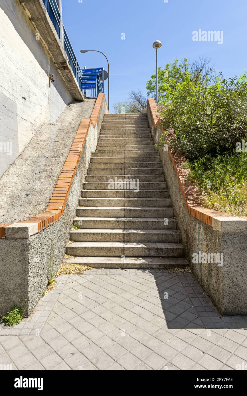 Some stairs with granite steps to bridge a large unevenness in the city ...