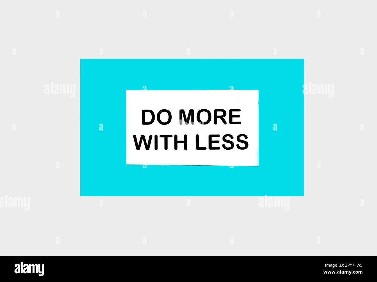 Do more with less. text on a green notepad on a light background Stock ...