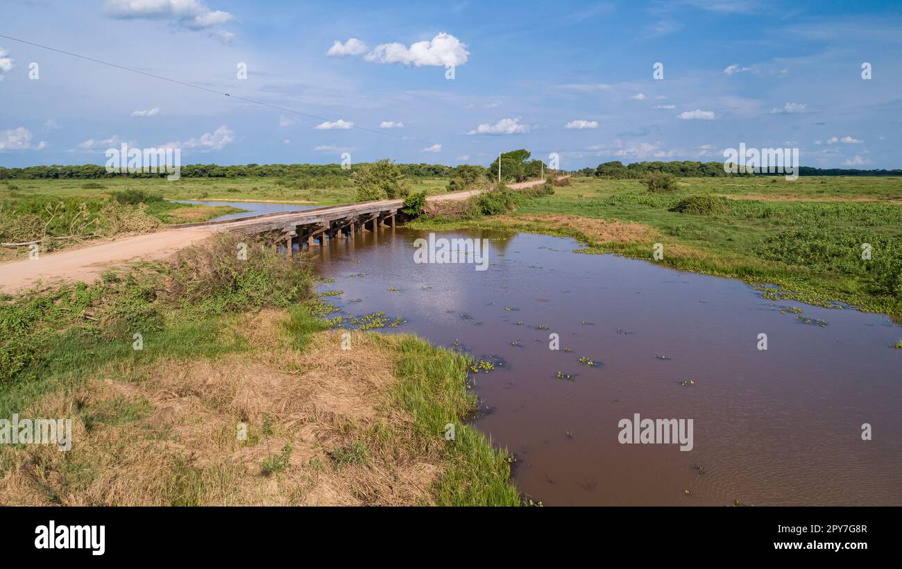 Aerial view of Transpantaneira wooden bridge crossing a river, sunny ...