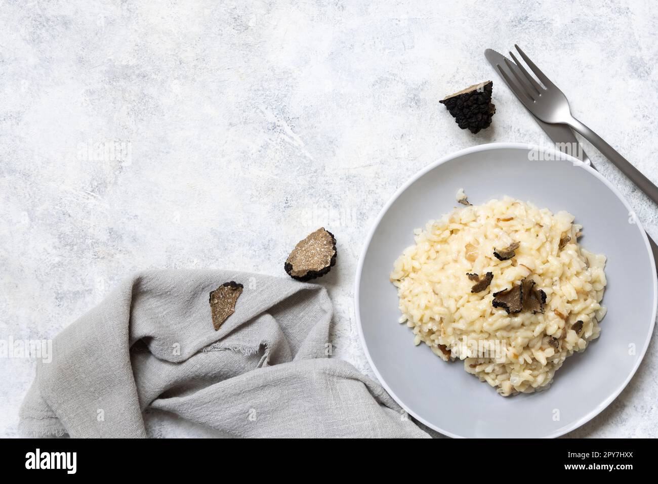 Risotto with porcini mushrooms and black truffles served in a plate top ...