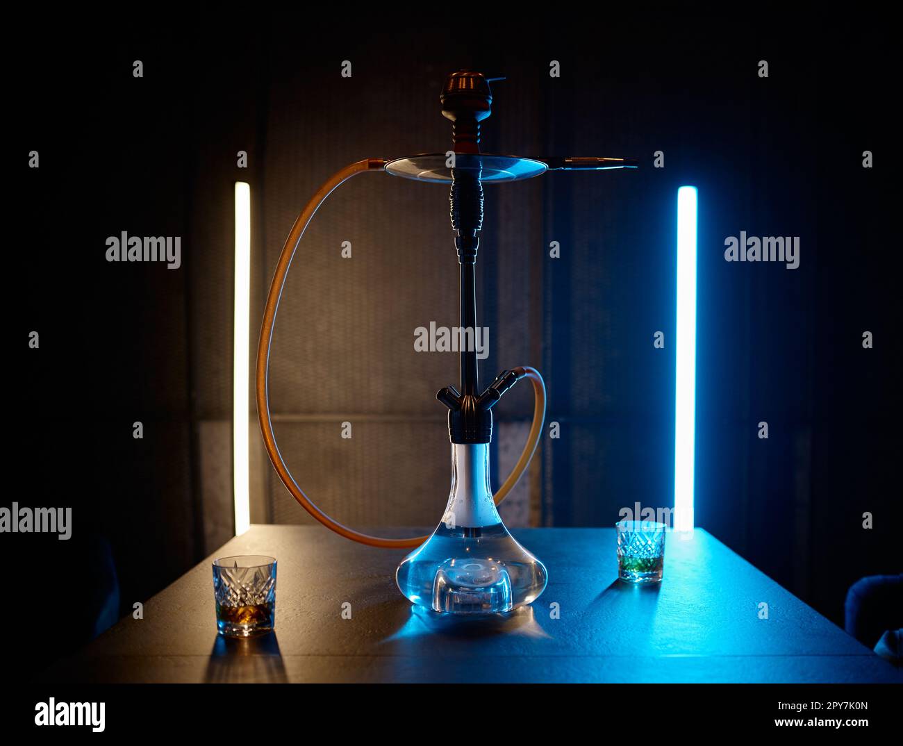 Hookah on table with glasses filled brandy in neon light Stock Photo ...