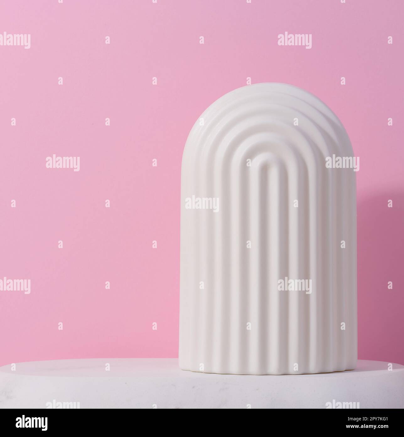 White ceramic decorative arch on a pink background, background for ...