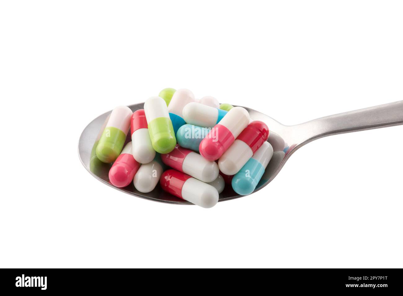 Colorful pills on spoon isolated on white background with clipping path ...