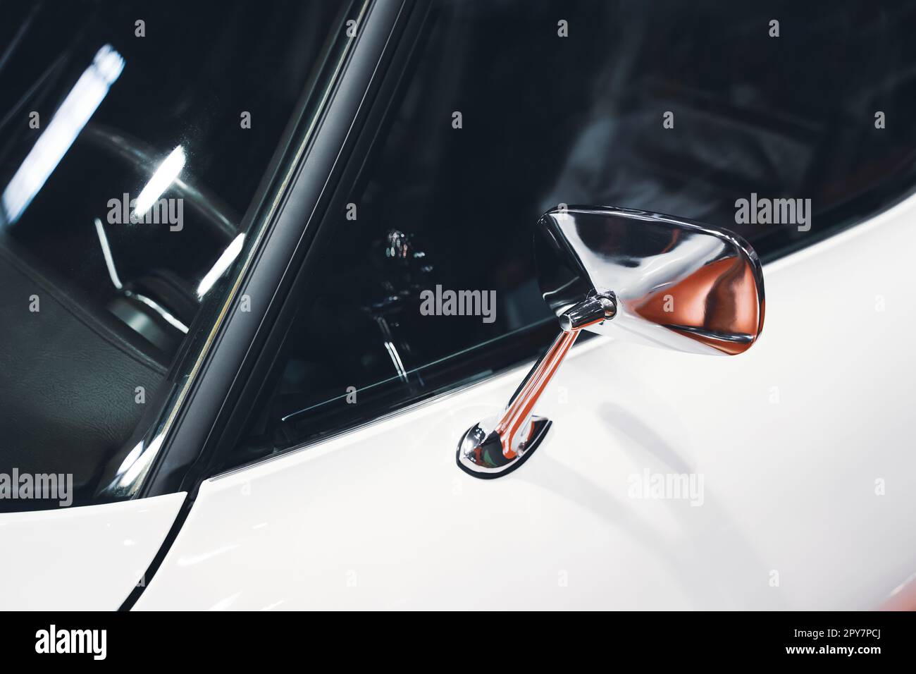 chrome rear mirror on white car with classic design Stock Photo - Alamy