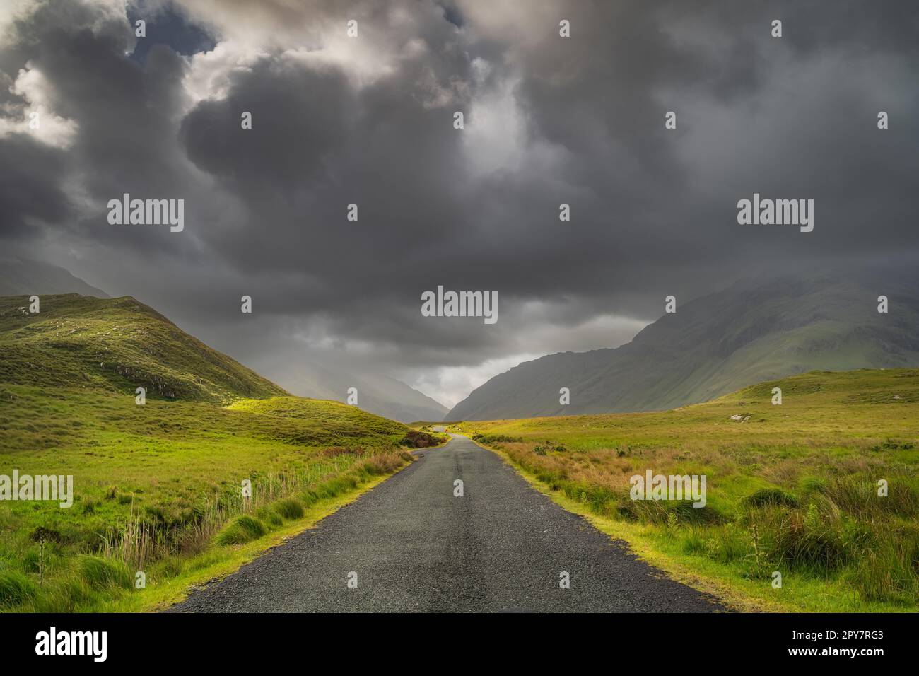 Road leading trough Doolough Valley, between mountain ranges, Ireland ...