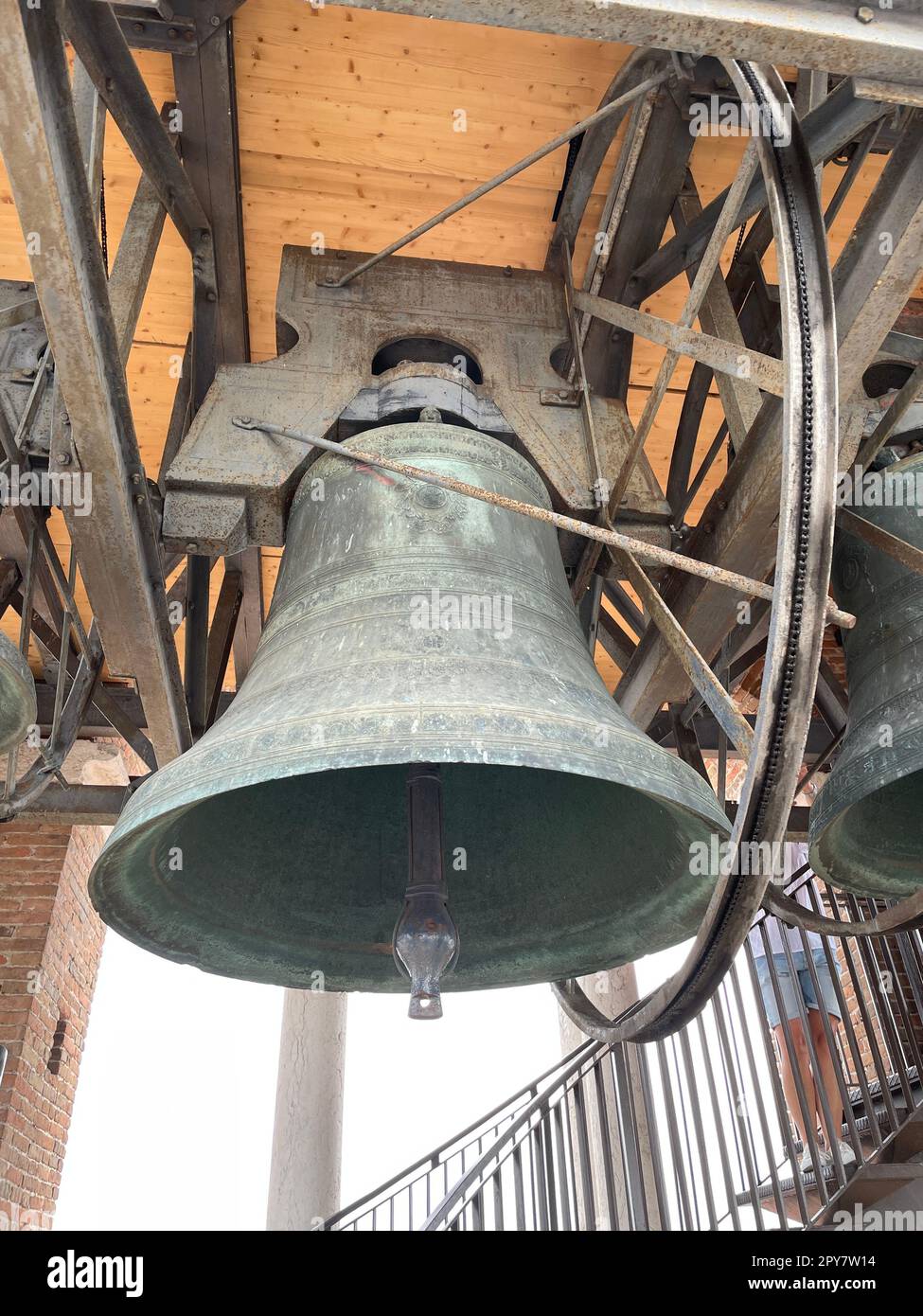 A big bell attached to a beam of wood Stock Photo - Alamy