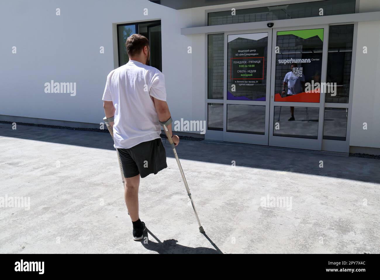 VYNNYKY, UKRAINE - MAY 1, 2023 - A man stands at the doors of the ...