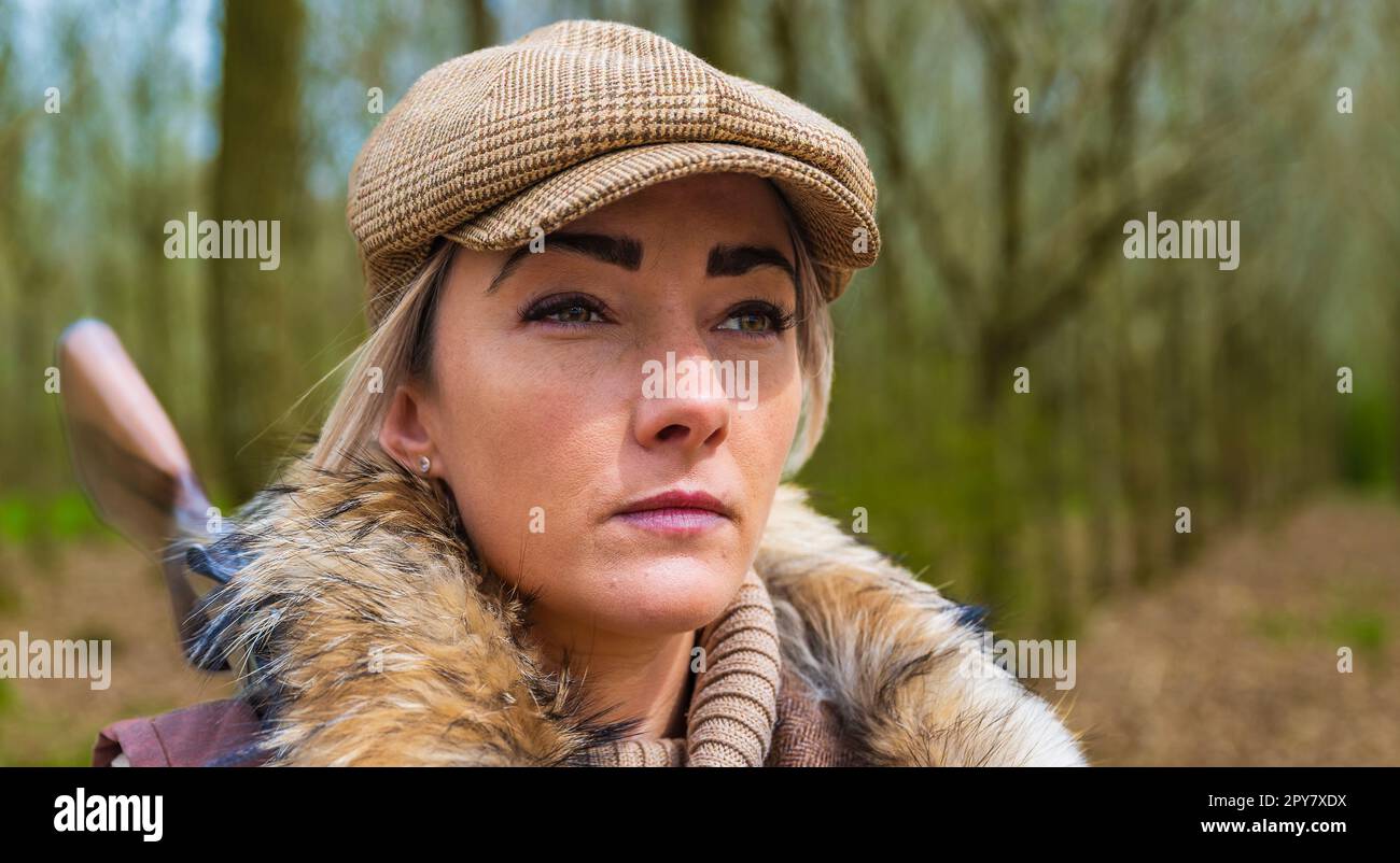 A thirty plus year old woman shooting in woodlands in the late spring ...