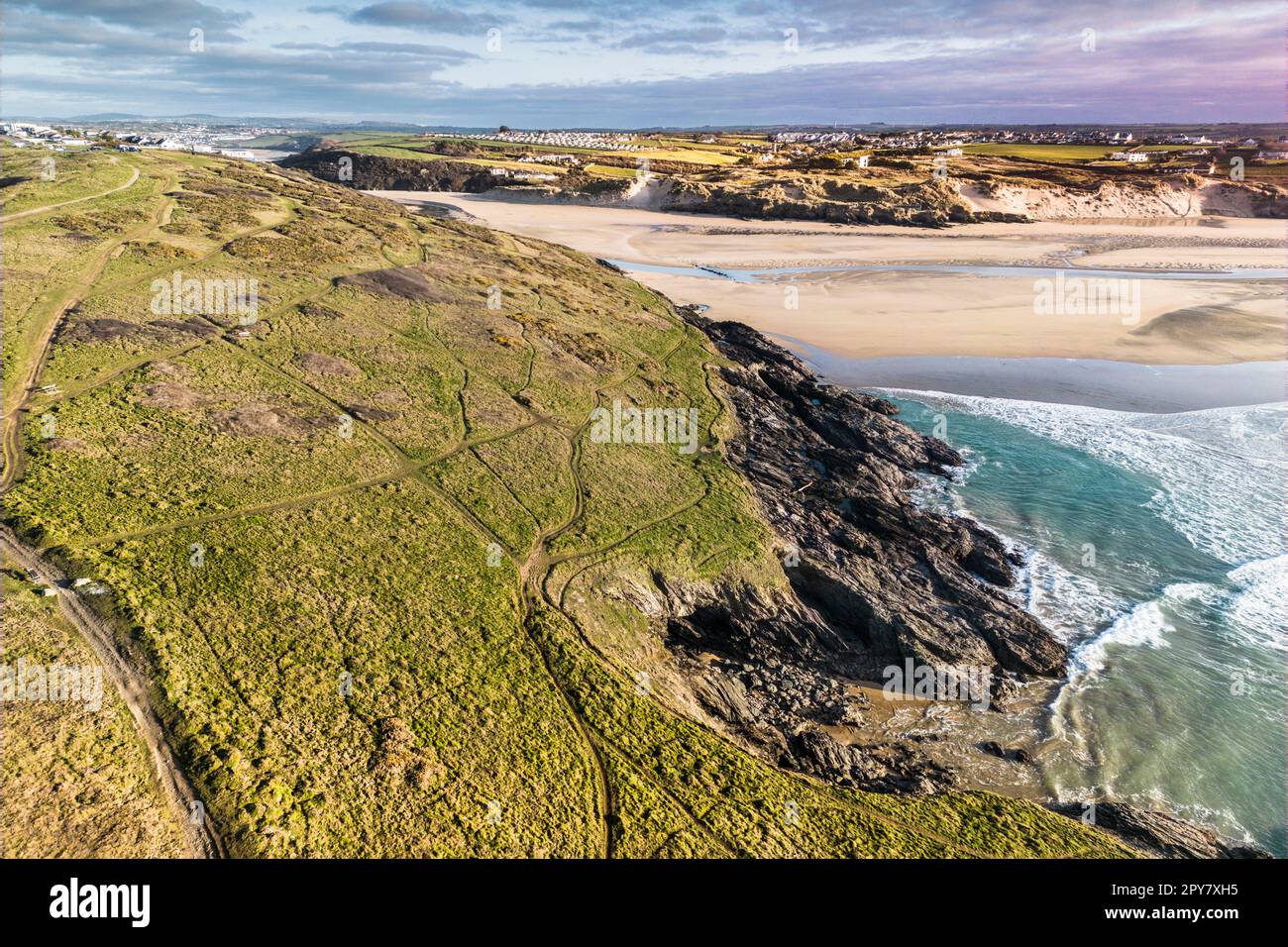 An aerial view of footpaths on Pentire Polint East and incoming tide on ...