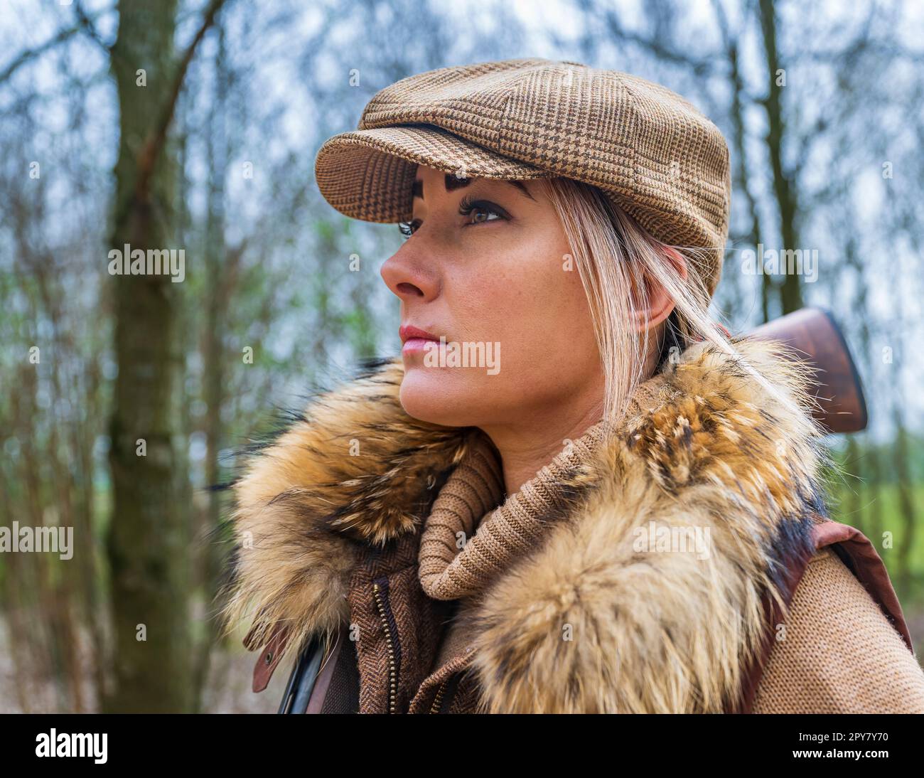 A thirty plus year old woman shooting in woodlands in the late spring ...