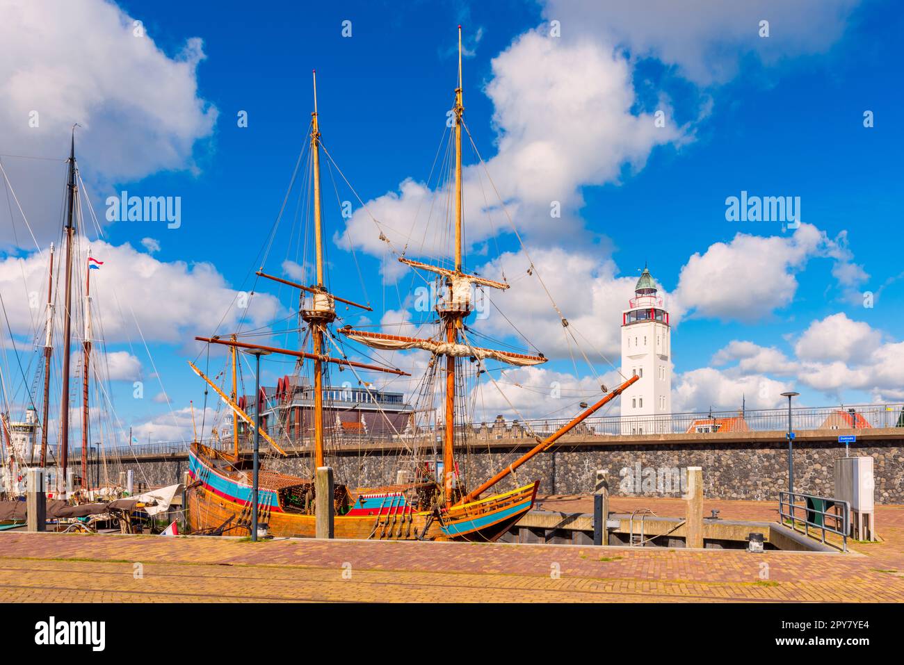 Old Ship and Lighthouse in the harbor of Harlingen, Friesland Province ...