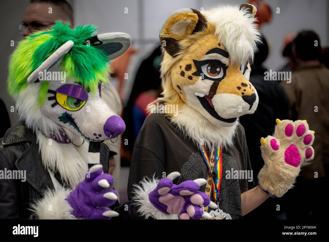Two people wearing animal masks attending a carnival or event ...