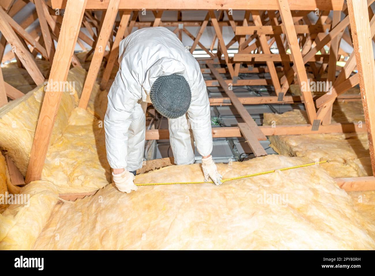 thermal insulation of roof spaces with glass wool Stock Photo - Alamy