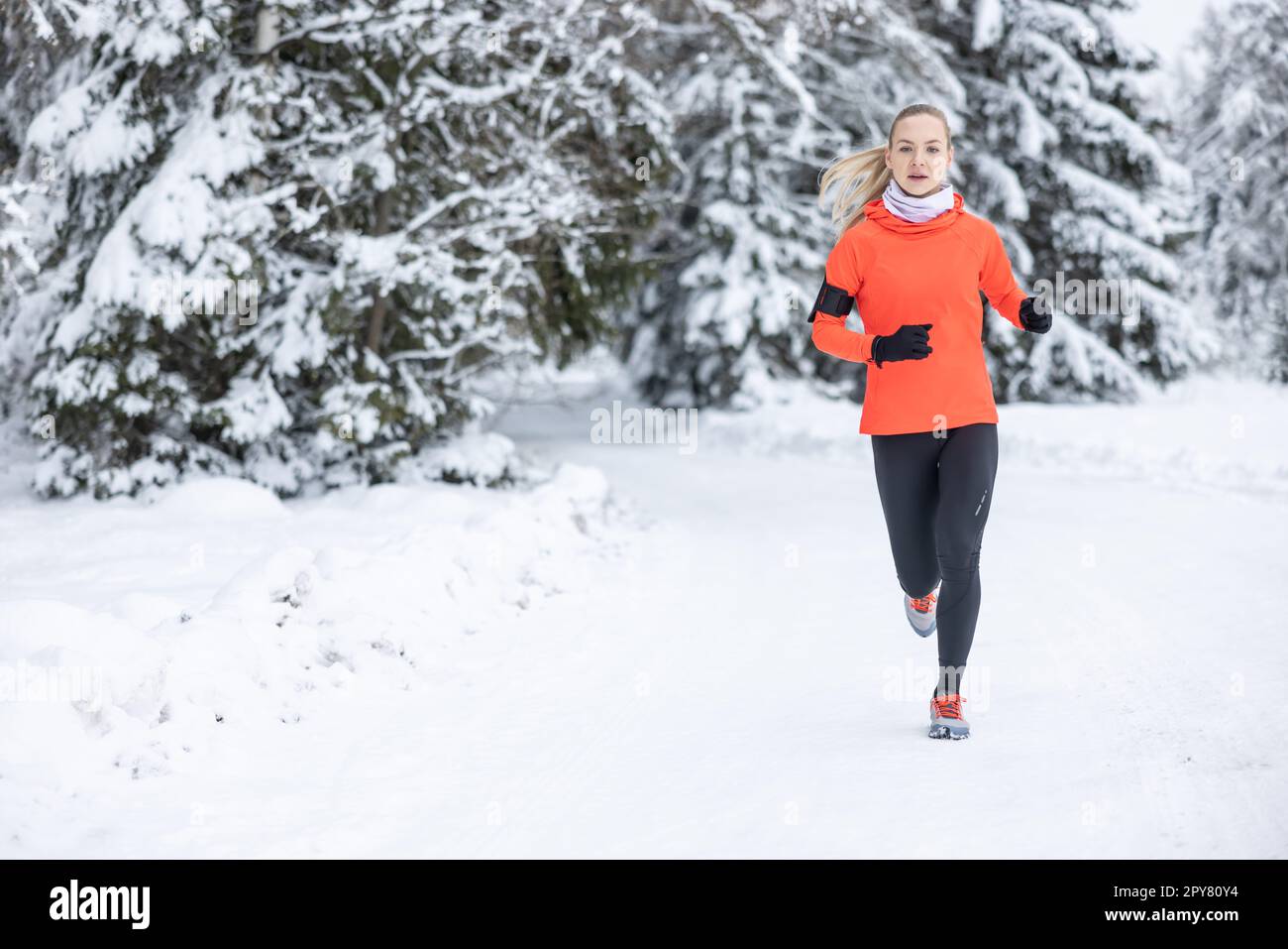 Woman running in forest training and exercising for trail run endurance ...