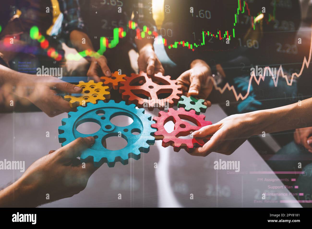 Teamwork of business people work together and combine pieces of gears ...