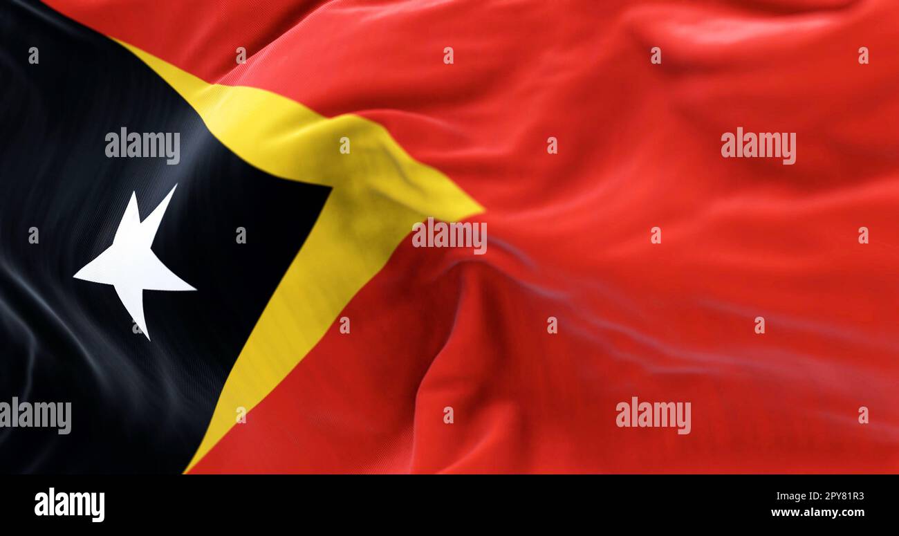 Detail of East Timor National flag waving. Red background with a yellow ...