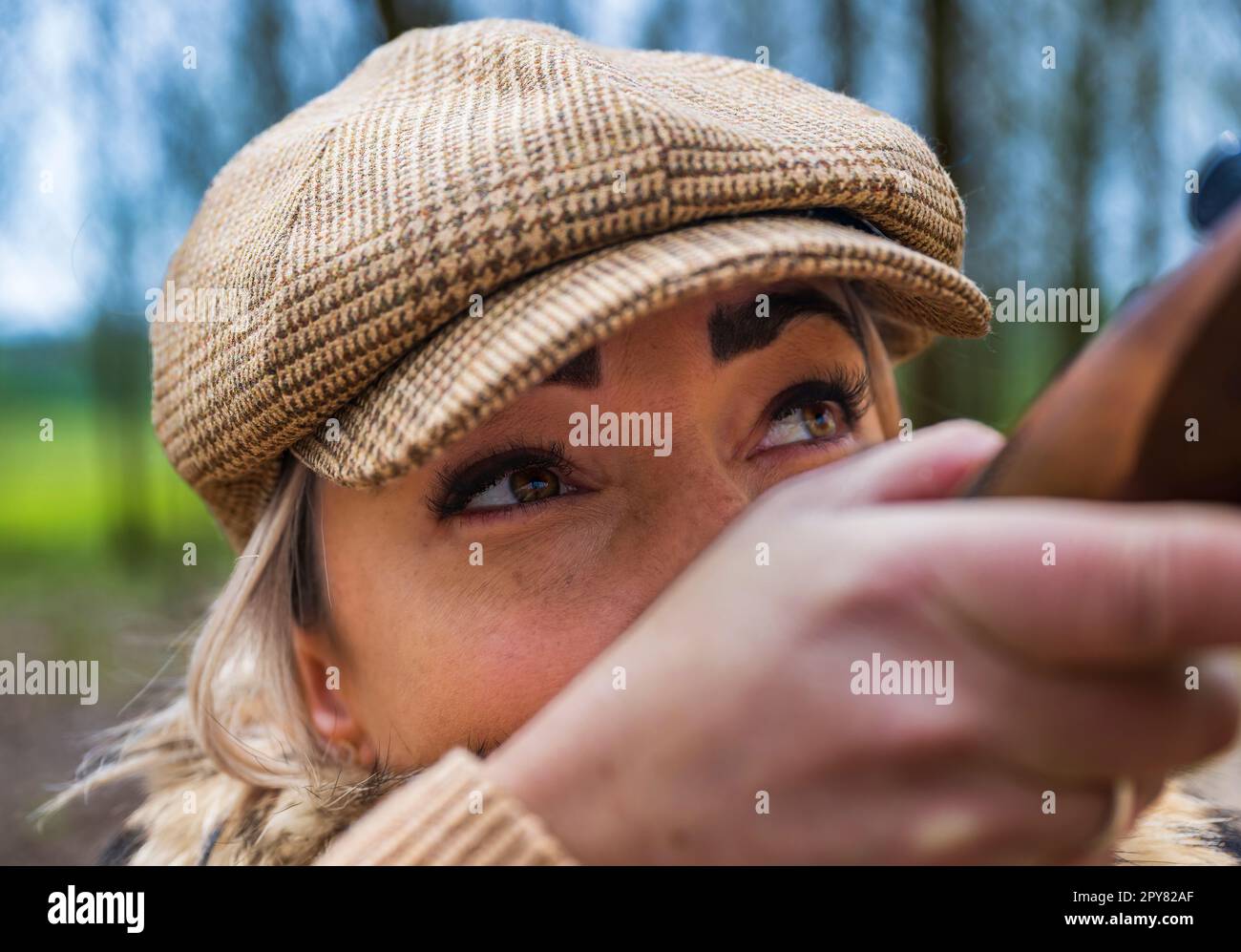 A thirty plus year old woman shooting in woodlands in the late spring ...