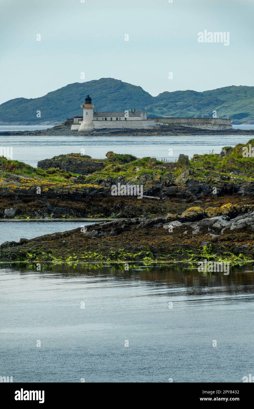View of Fladda lighthouse from Luing island near Oban, Argyll, Scotland ...