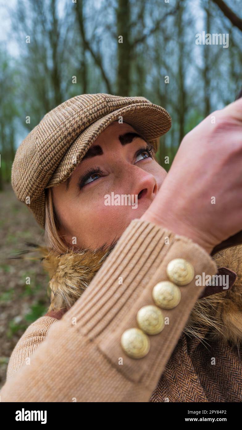 A thirty plus year old woman shooting in woodlands in the late spring ...