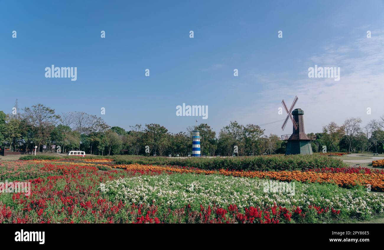A scenic outdoor scene with a traditional windmill surrounded by lush ...