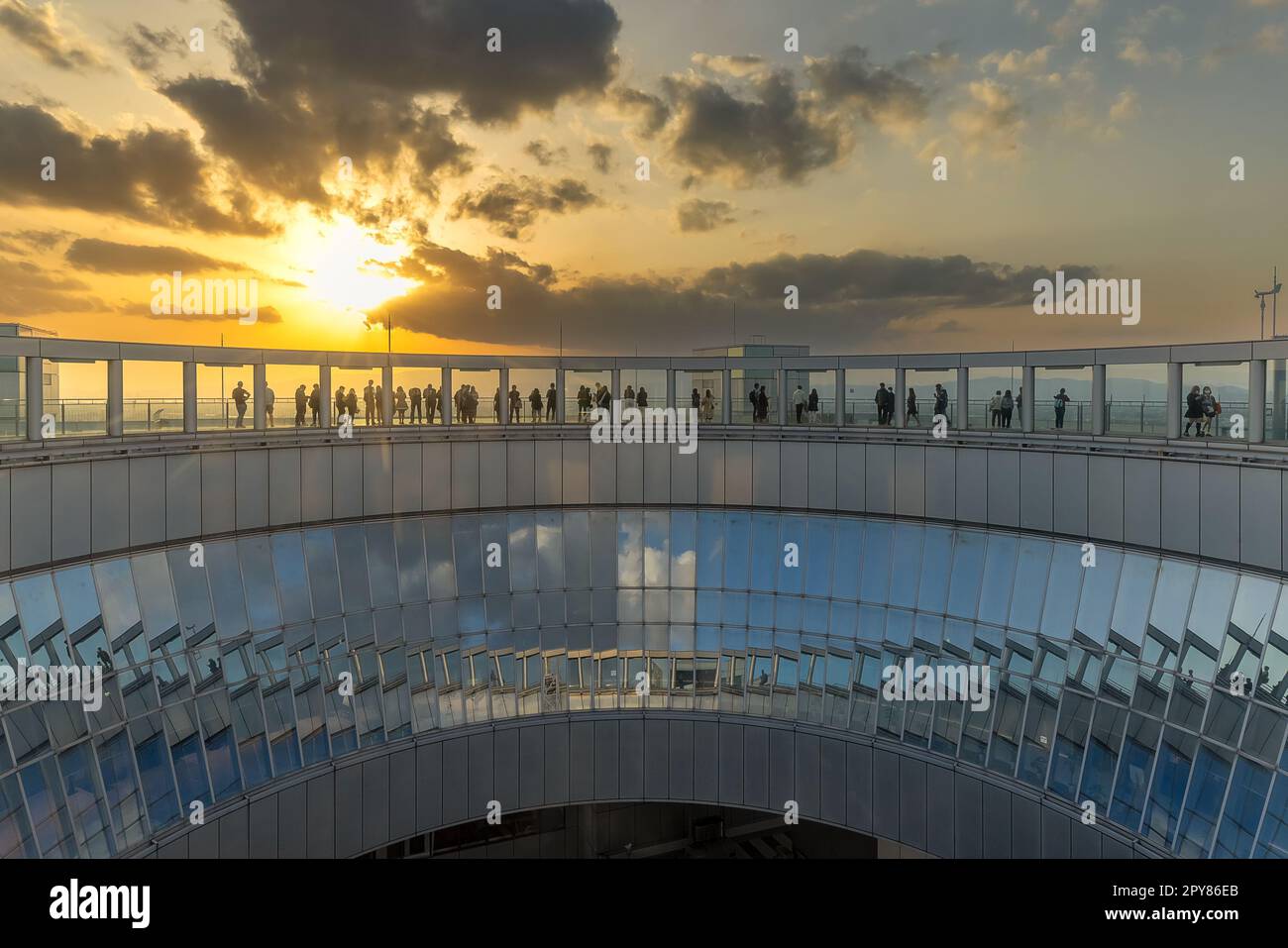 A group of people standing on the edge of Kuchu Teien Observatory in ...