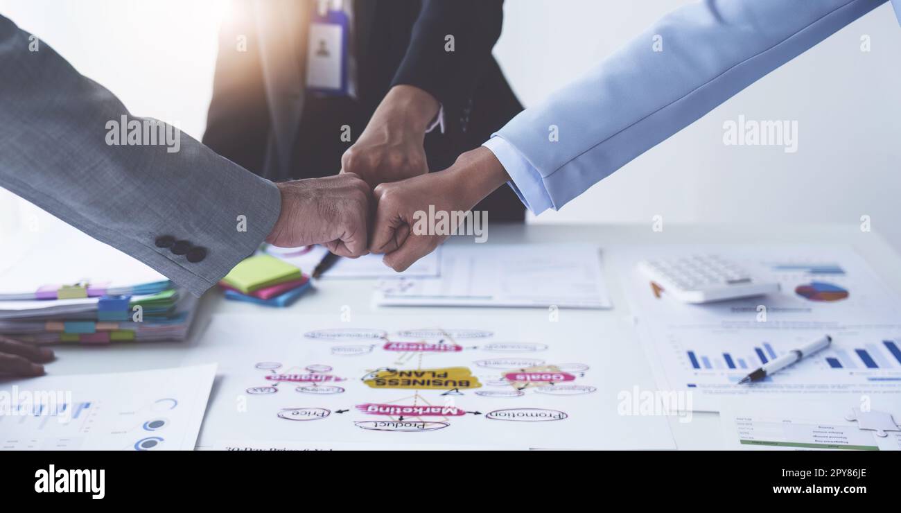 Group of business people putting their hands working together on wooden ...