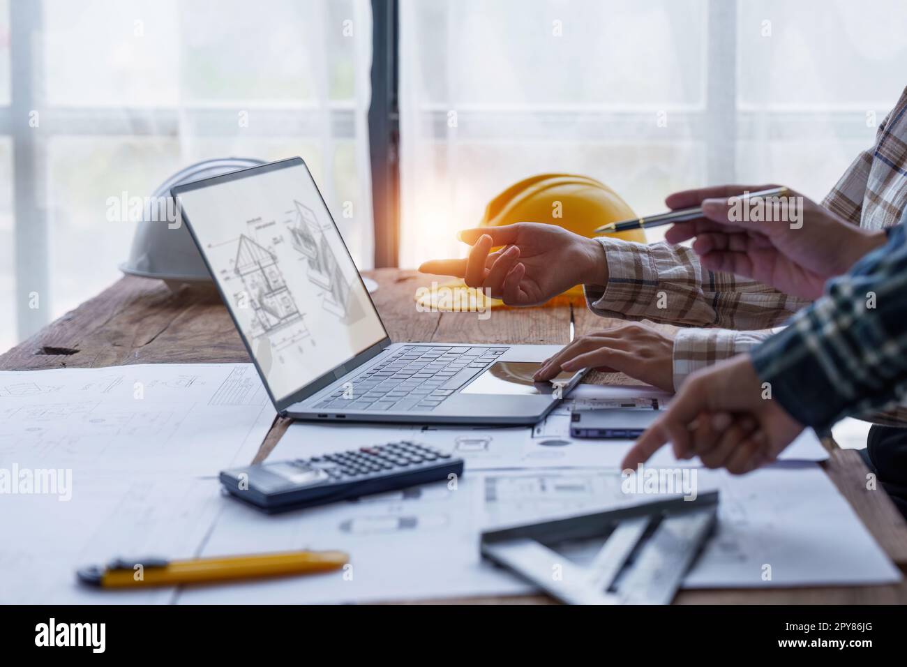 Architect and Engineer working with blueprints for architectural plan ...