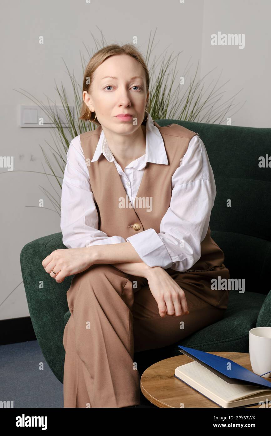 Confident and positive woman seated in indoors setting Stock Photo - Alamy