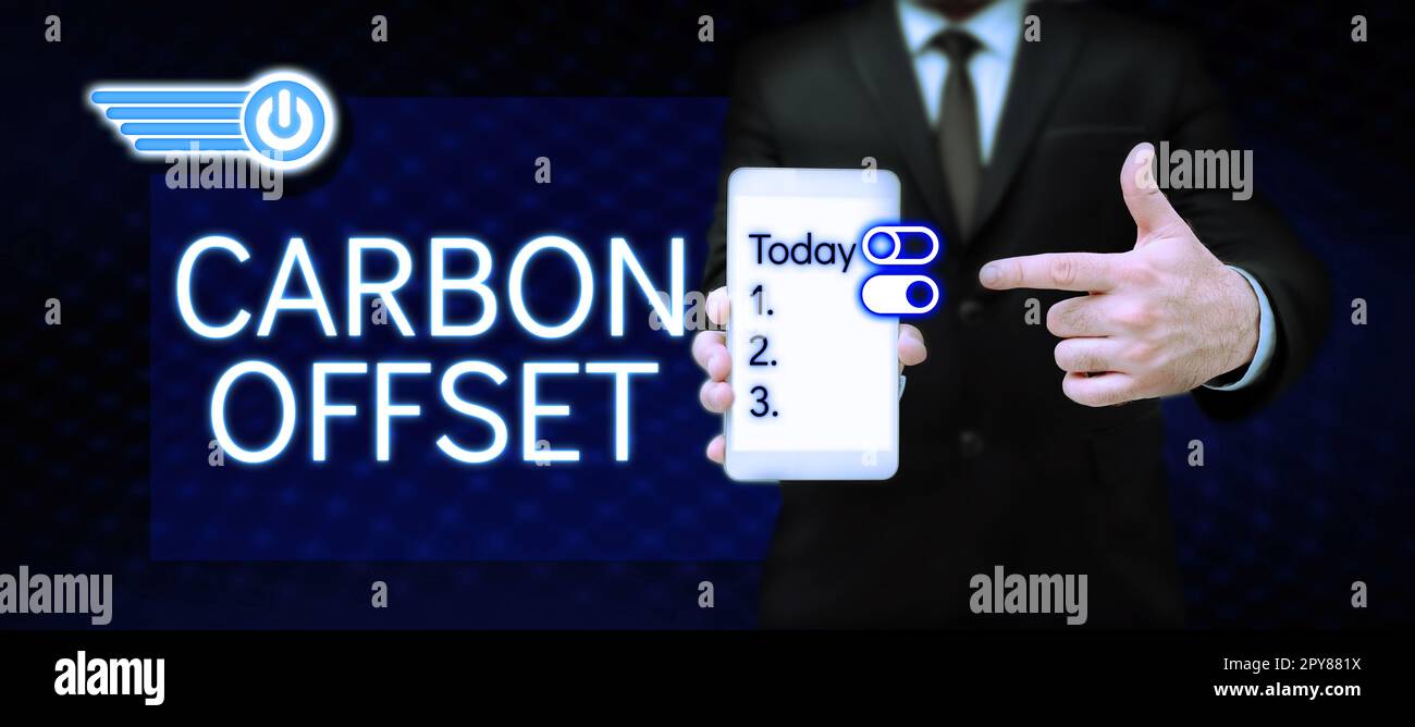 Hand writing sign Carbon Offset. Word Written on Reduction in emissions ...