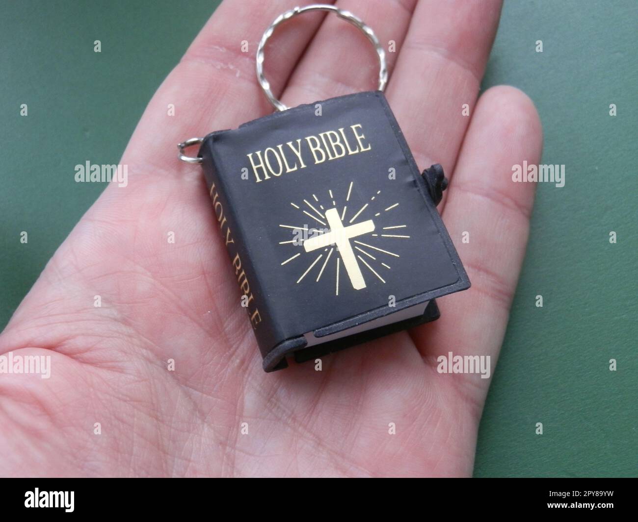 Religious metal symbol medallion in hand Stock Photo - Alamy