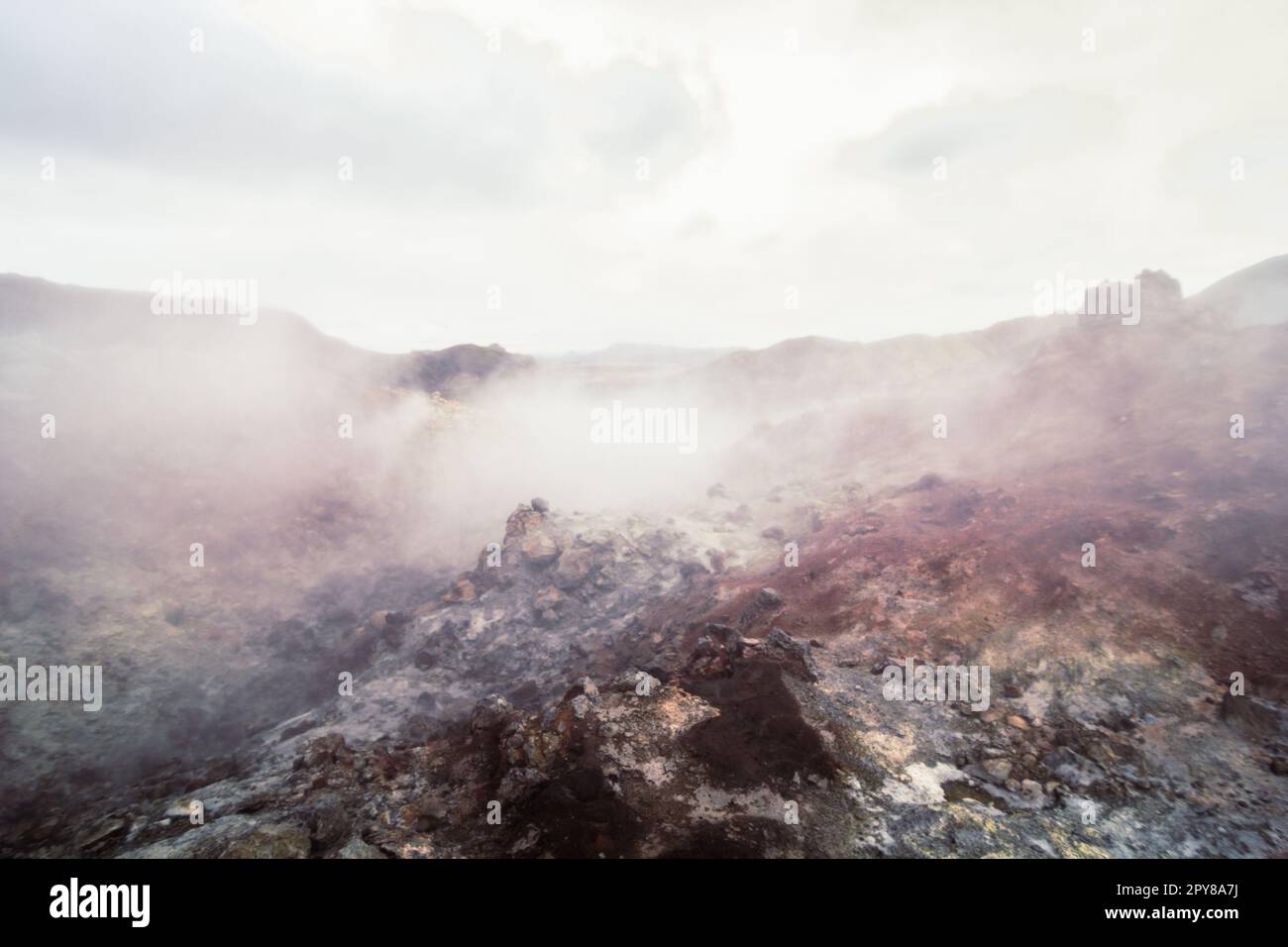 Steam over geyser landscape photo Stock Photo - Alamy