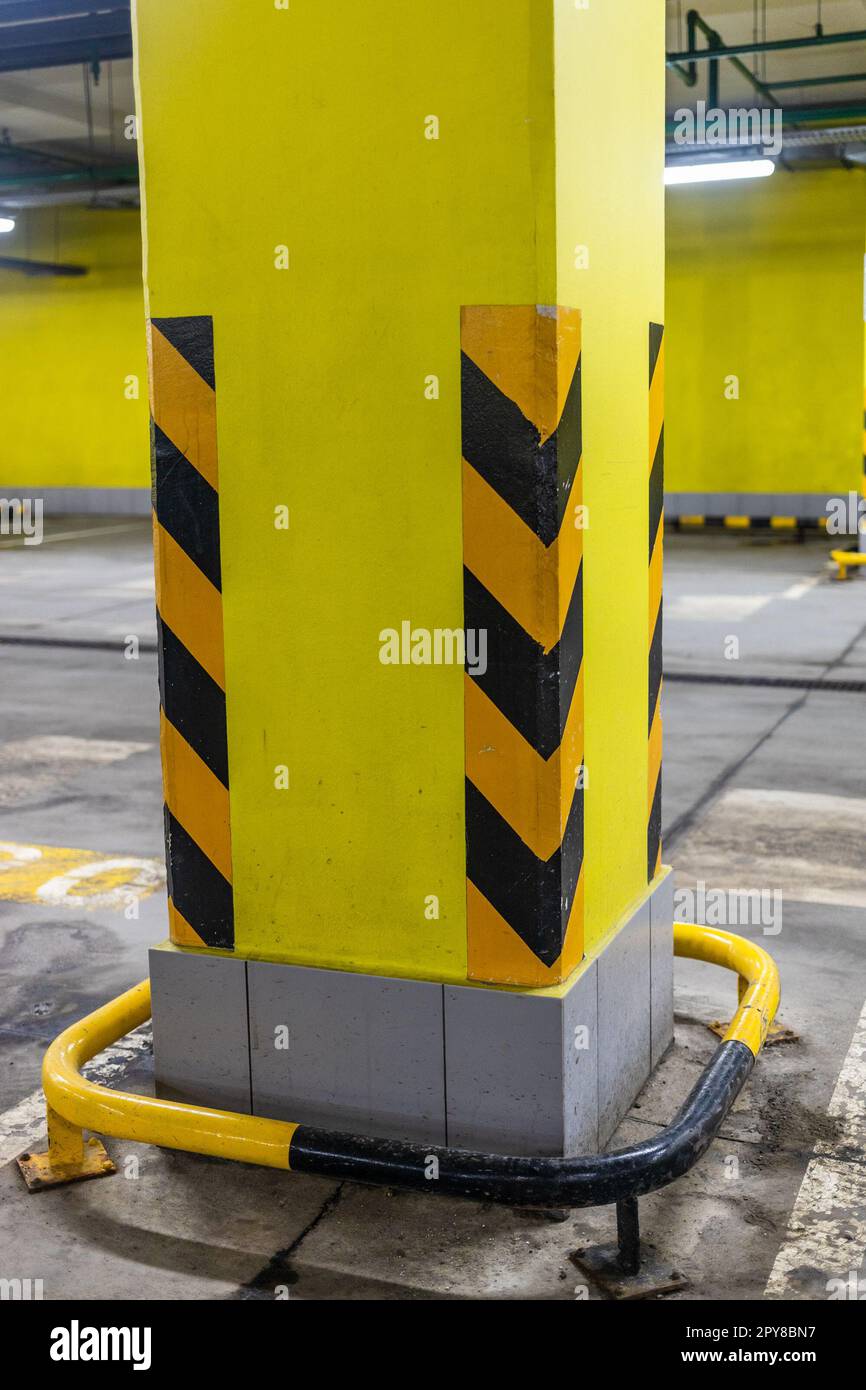 yellow post on underground parking area Stock Photo - Alamy
