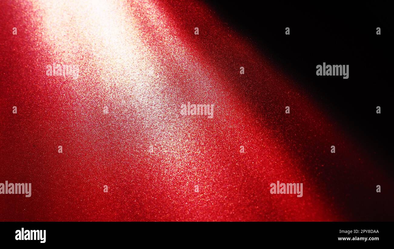 Diagonal rays of light on a red or scarlet background. Blurred abstract ...