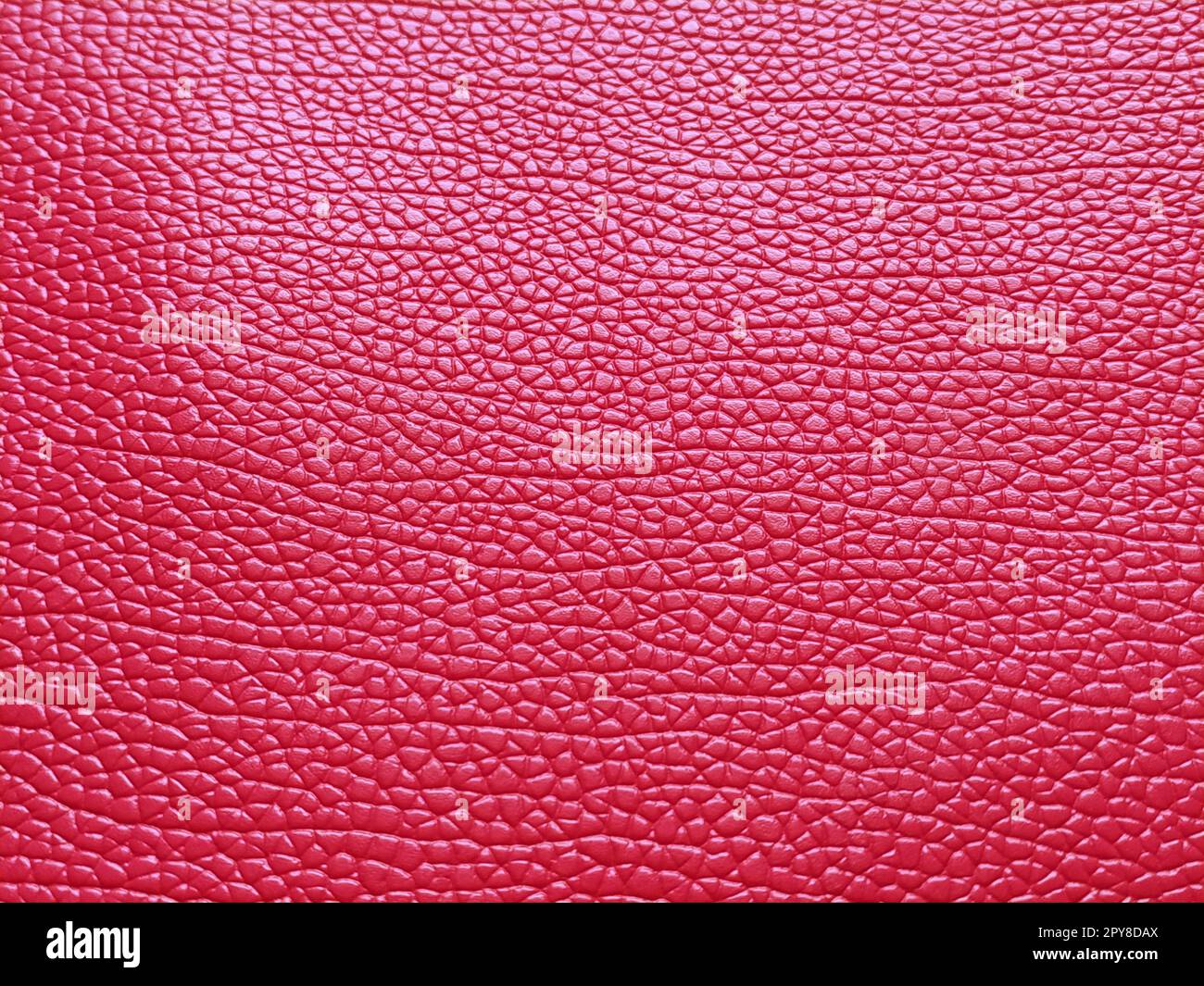 Faux red leather. Separate grooves and elevations on the surface of a ...