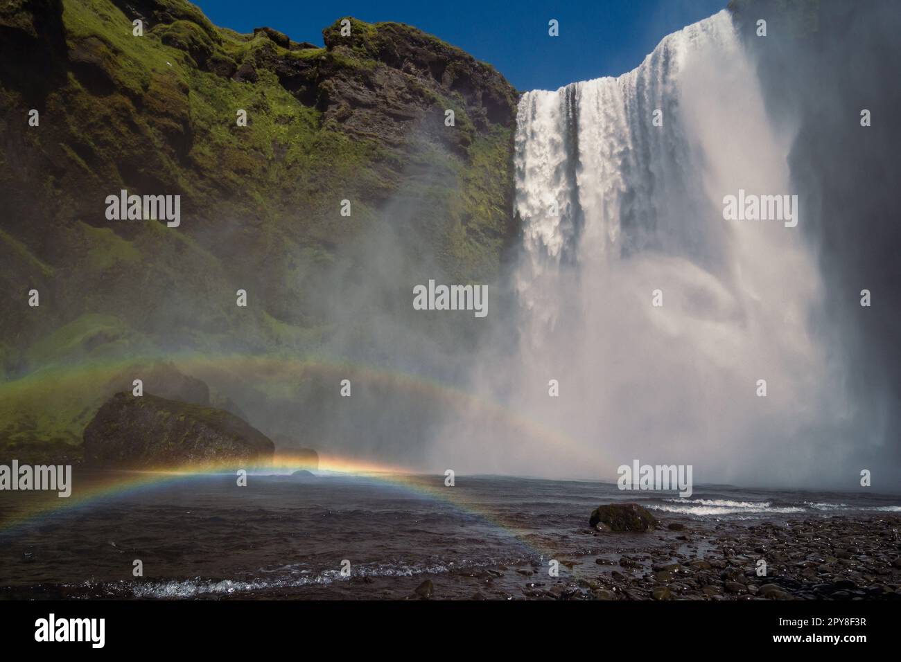 Rainbow near large waterfall landscape photo Stock Photo - Alamy