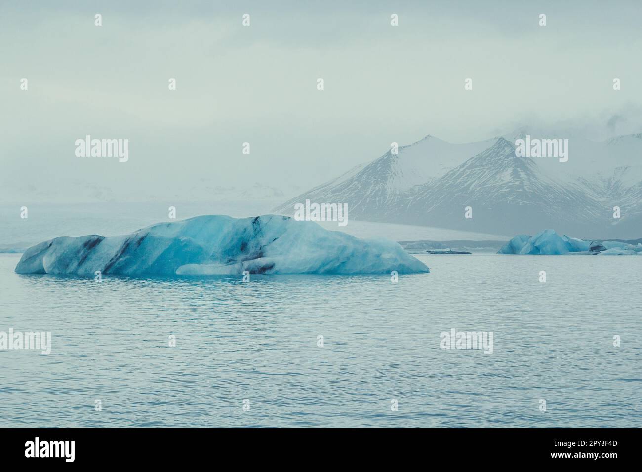 Striped iceberg floating in sea landscape photo Stock Photo - Alamy