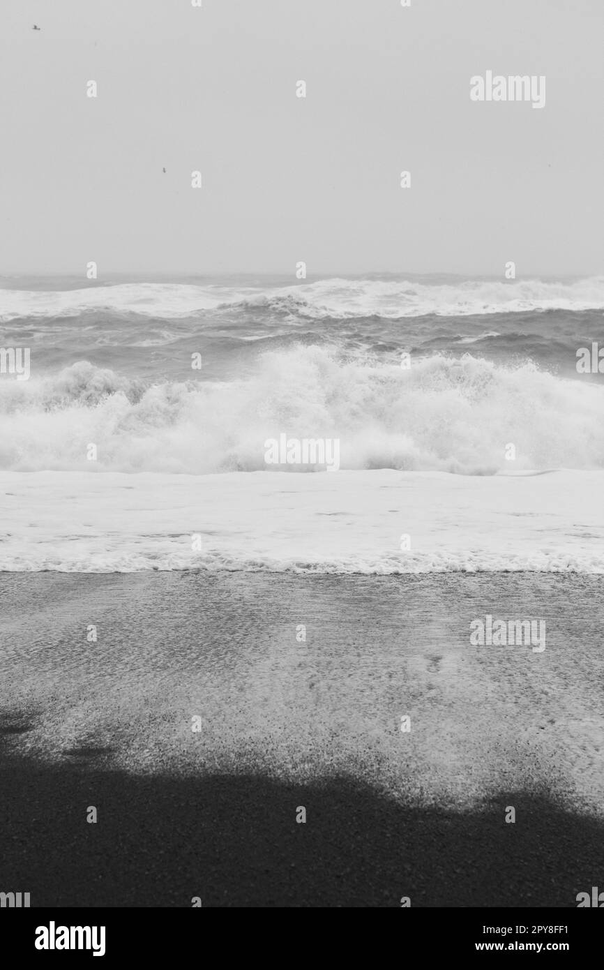 Foam pattern on black sand monochrome landscape photo Stock Photo - Alamy