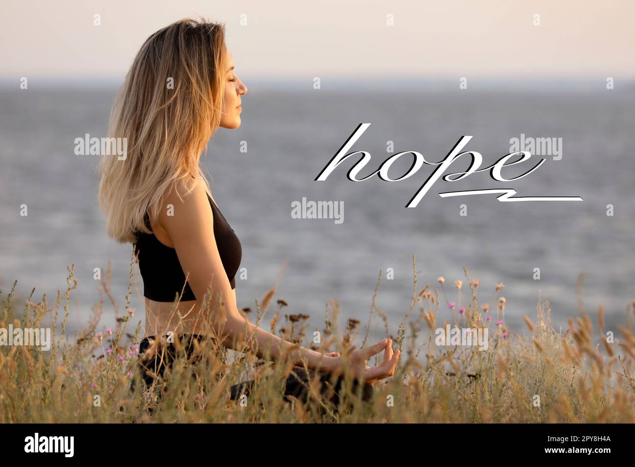 Concept of hope. Woman meditating near sea Stock Photo - Alamy