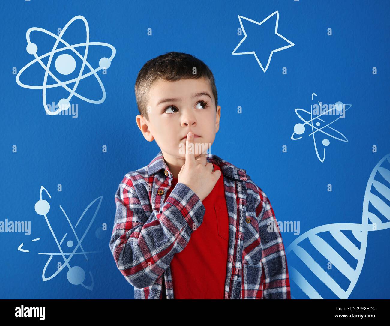 Thoughtful little boy on blue background with different drawings Stock ...