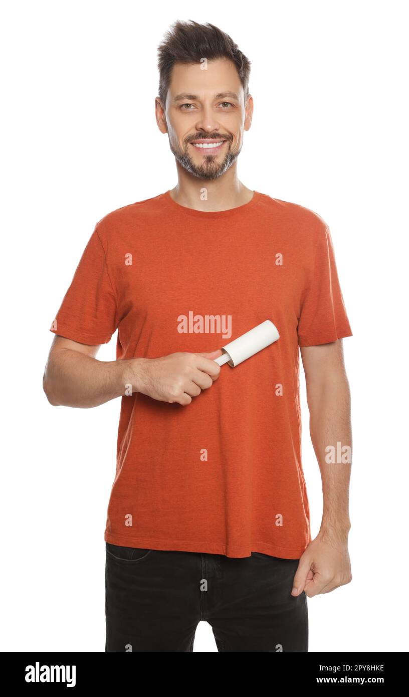 Handsome man using lint roller on white background Stock Photo - Alamy