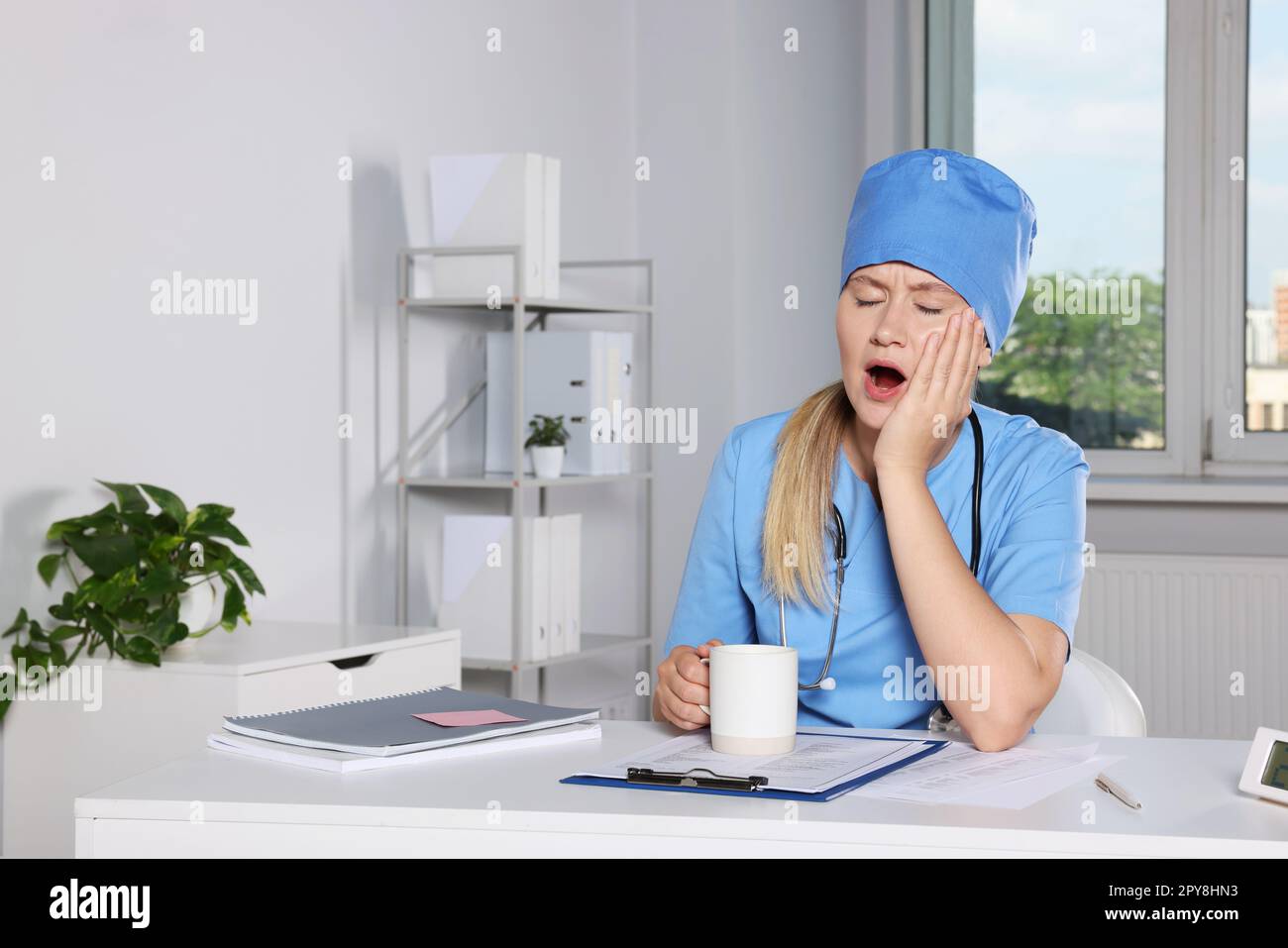 Medical doctor woman yawning in hi-res stock photography and images - Alamy