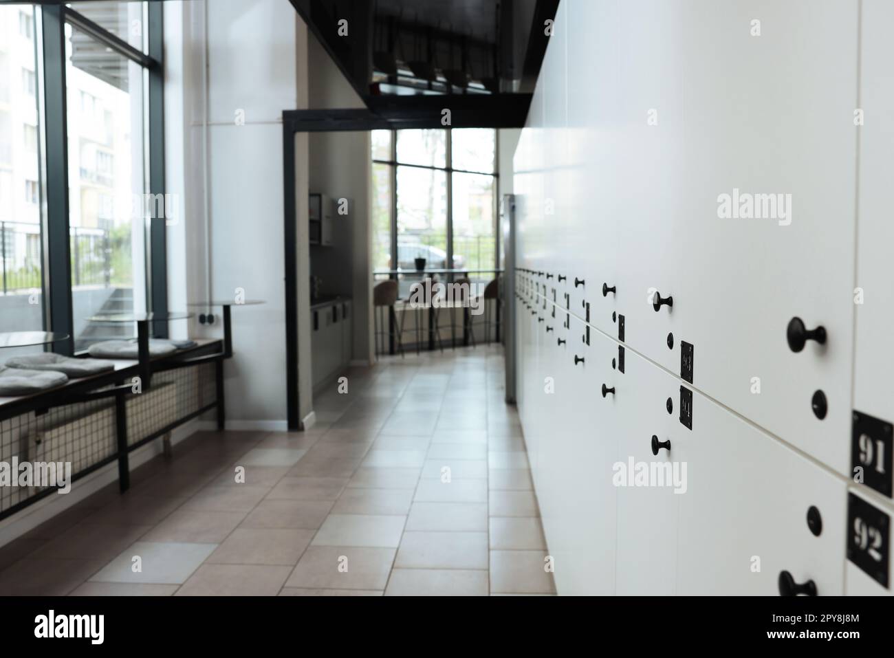 Hostel dining room interior with modern furniture and white lockers ...