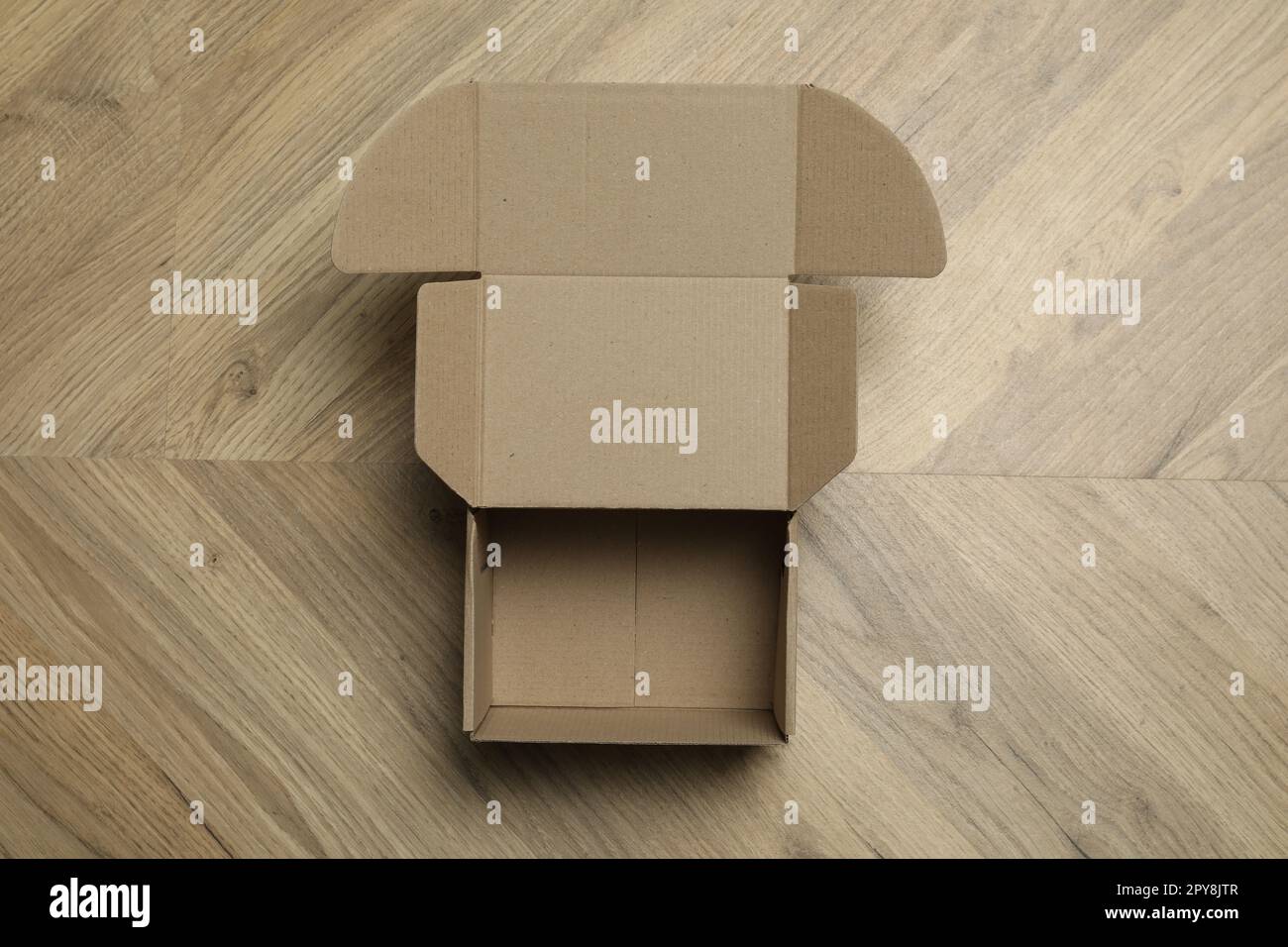 Empty open cardboard box on floor, top view Stock Photo - Alamy