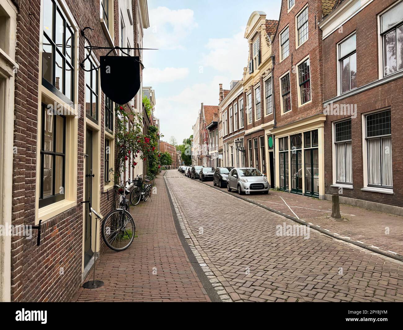 Beautiful view of city street with parked cars and bicycles Stock Photo ...