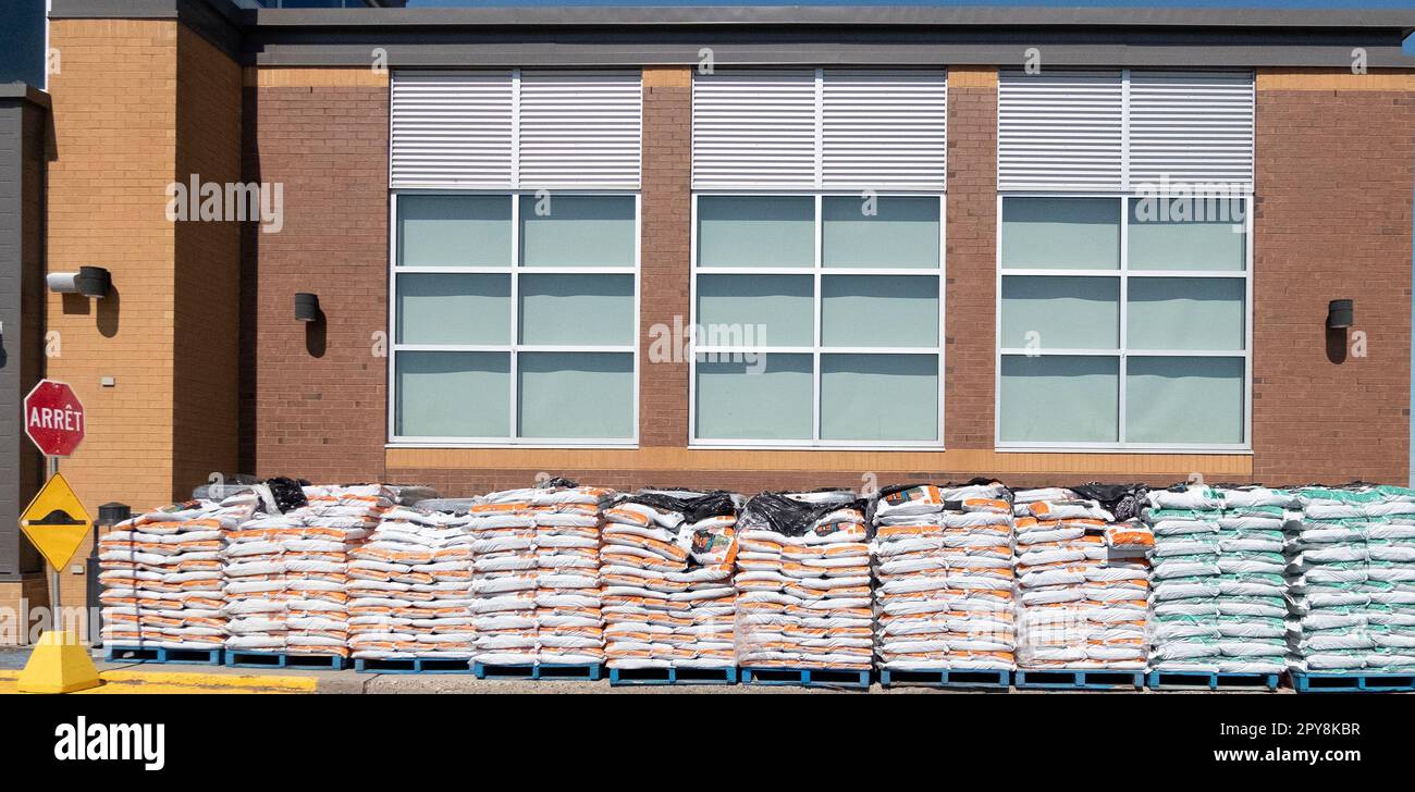The sacks of construction material under the windows of a brick ...