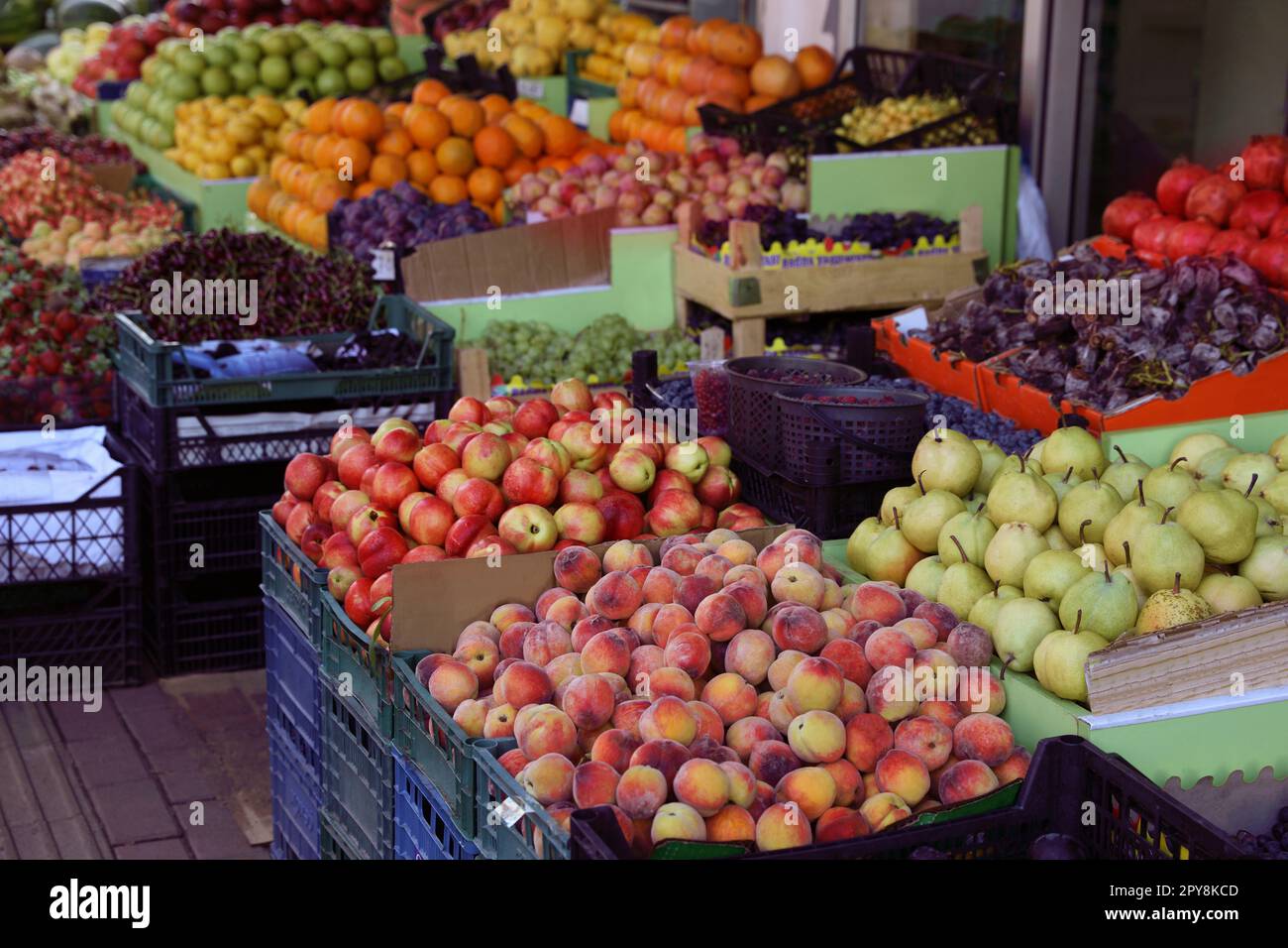 Many fruits and berries in crates selling outdoors Stock Photo - Alamy