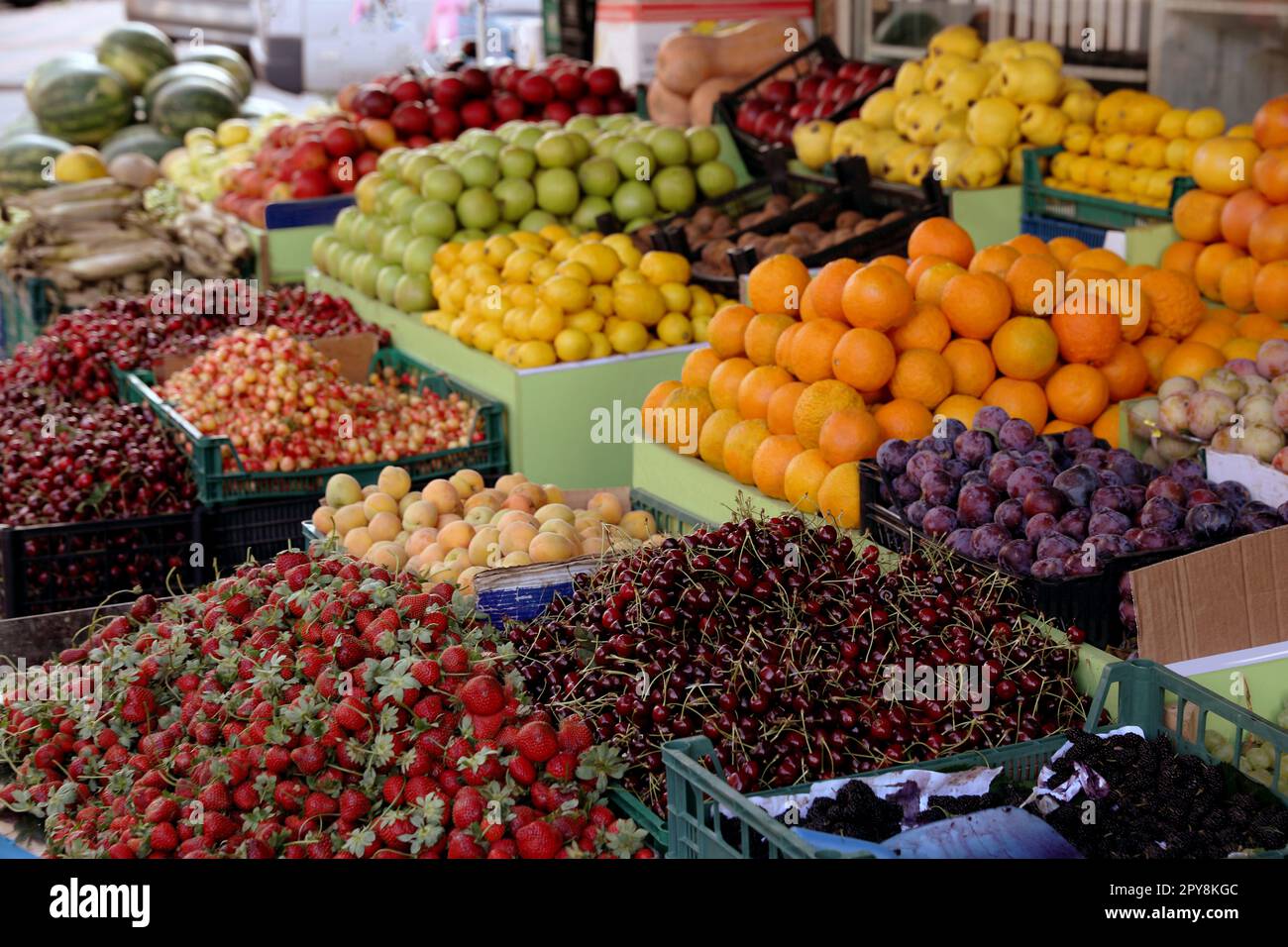Many fruits and berries in crates selling outdoors Stock Photo - Alamy