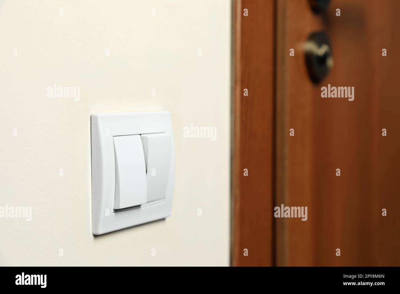 Modern plastic light switch on white wall indoors Stock Photo - Alamy