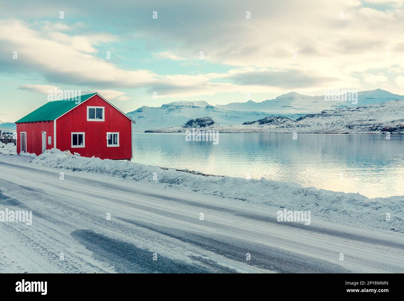 Red cabin on snowy sea coast landscape photo Stock Photo - Alamy