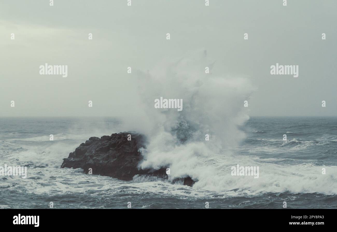 Large rock and water splash on storm landscape photo Stock Photo - Alamy